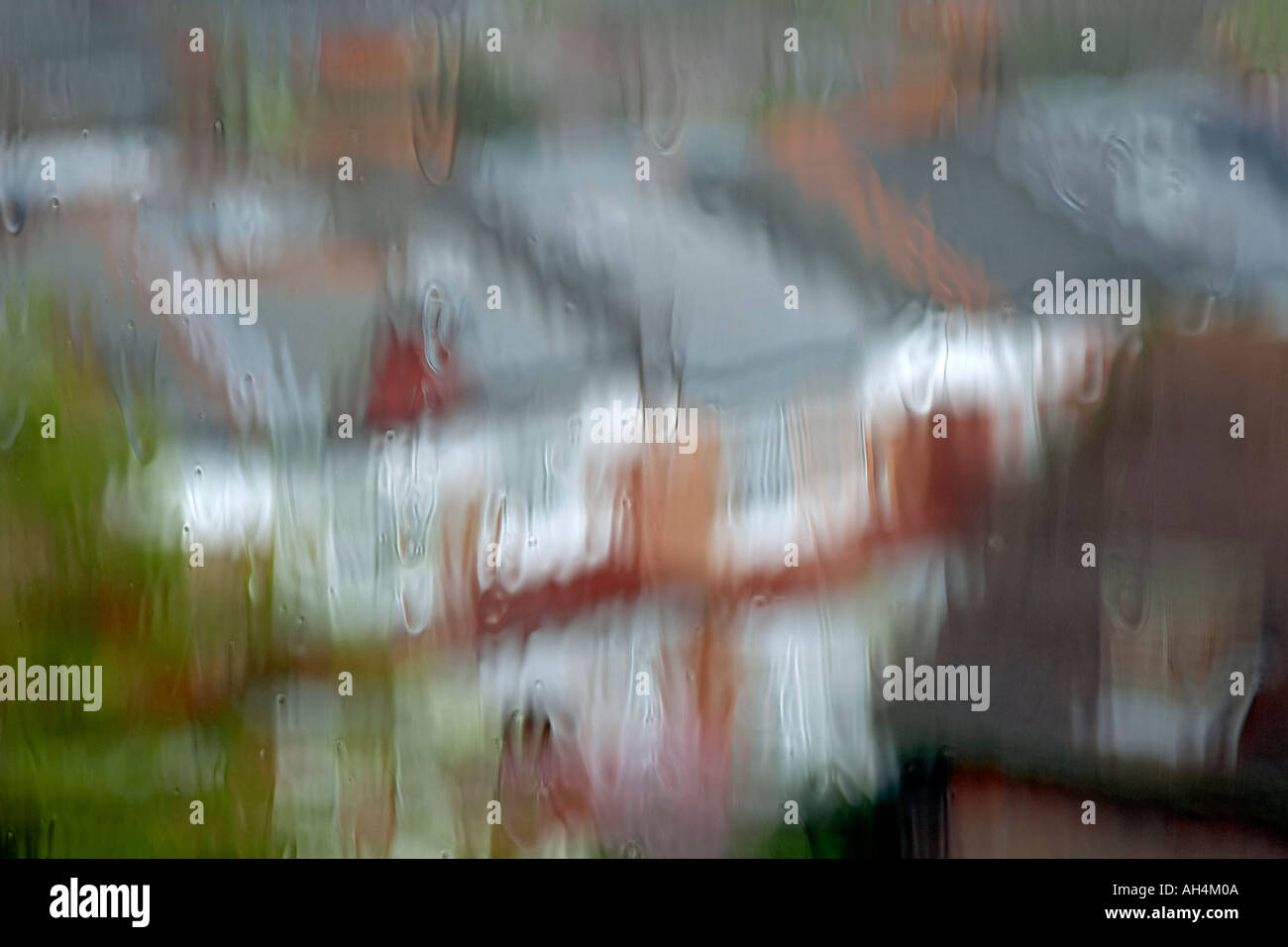 Rain on a window with trees and houses behind Stock Photo - Alamy
