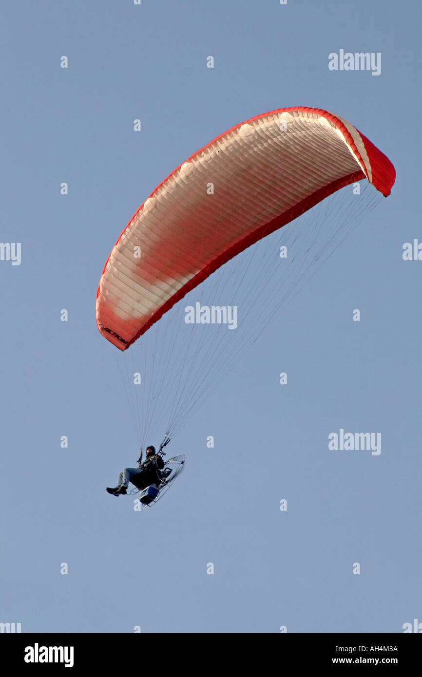 Foot launched paramotor pilot flying against blue sky near Alconbury ...