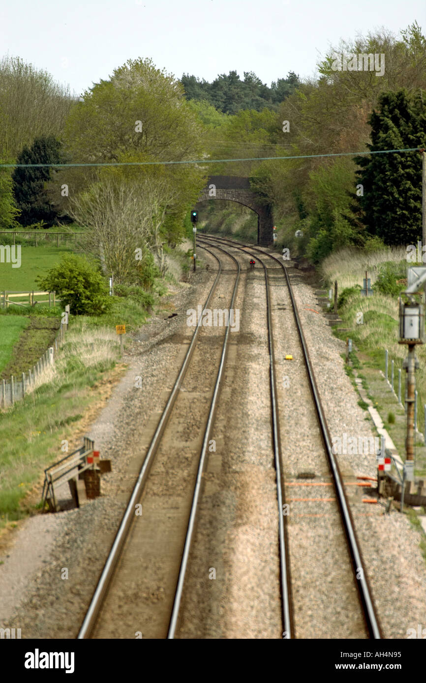 Two railway lines with green light bridge and tracks receding into the ...
