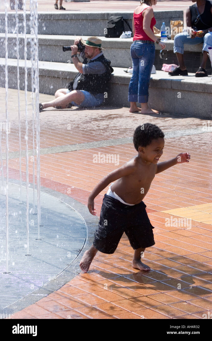 Water spewing on little boy at park fountain Stock Photo - Alamy