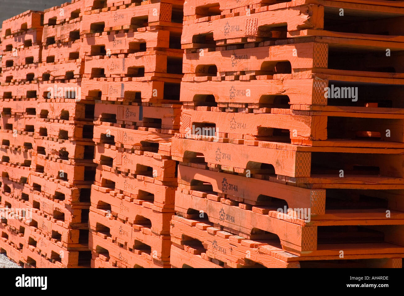 Stack of orange skids outside a munufacturer Stock Photo - Alamy