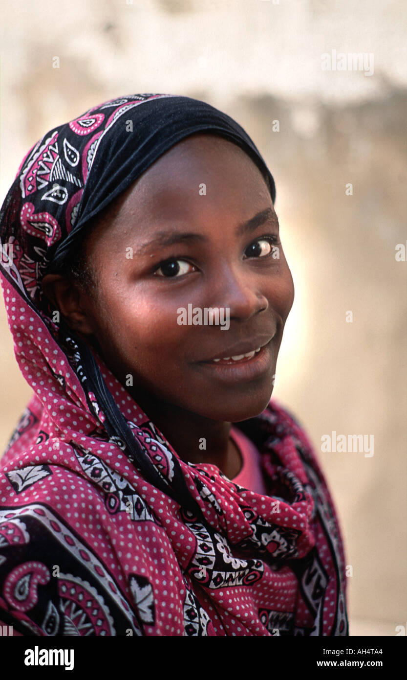 Portrait of a young Zanzibari woman wearing a colourful kanga Stone ...