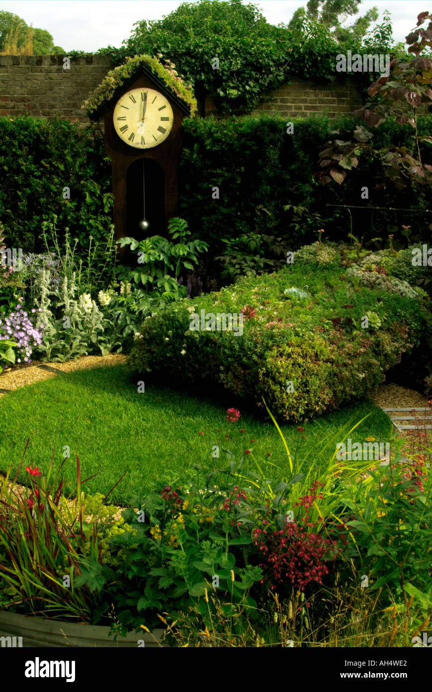 Circular lawn with garden clock Stock Photo - Alamy