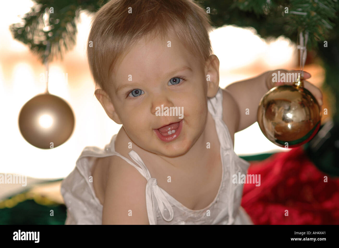 Baby under the tree with presents hi-res stock photography and images ...