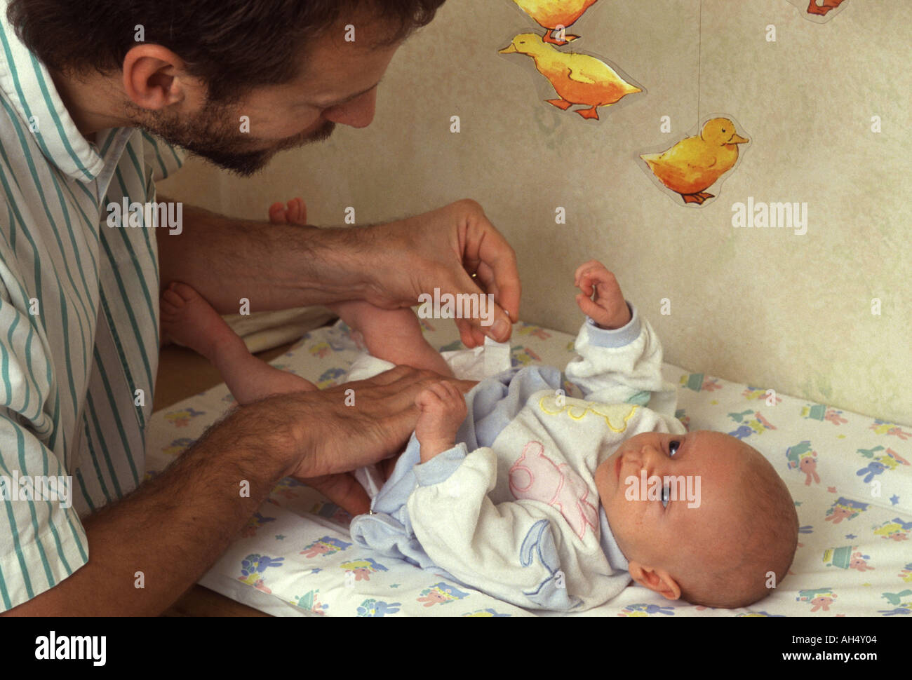 Father changing a nappy on a baby Stock Photo - Alamy