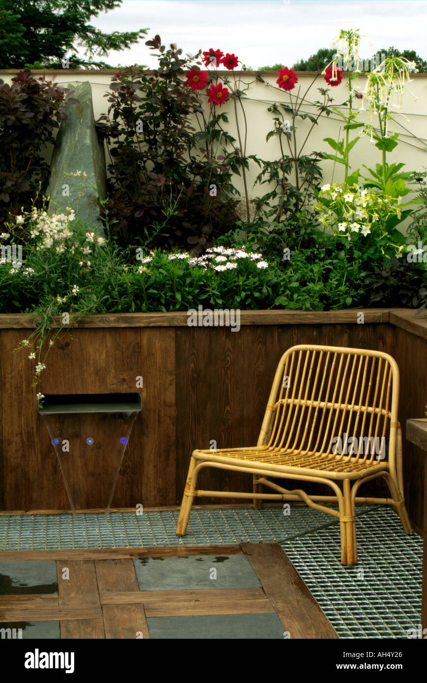 Garden seating area surrounded by raised beds and water feature Stock ...