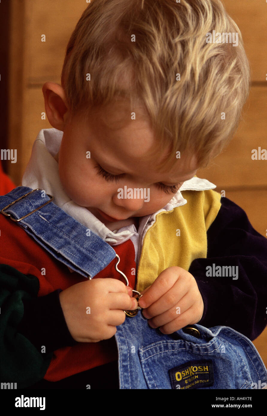 Little boy getting dressed on his own Stock Photo - Alamy