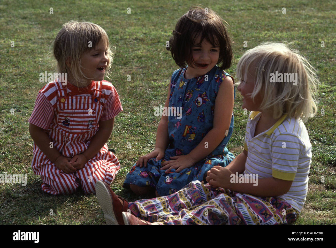 Three preschool children sitting together Stock Photo - Alamy