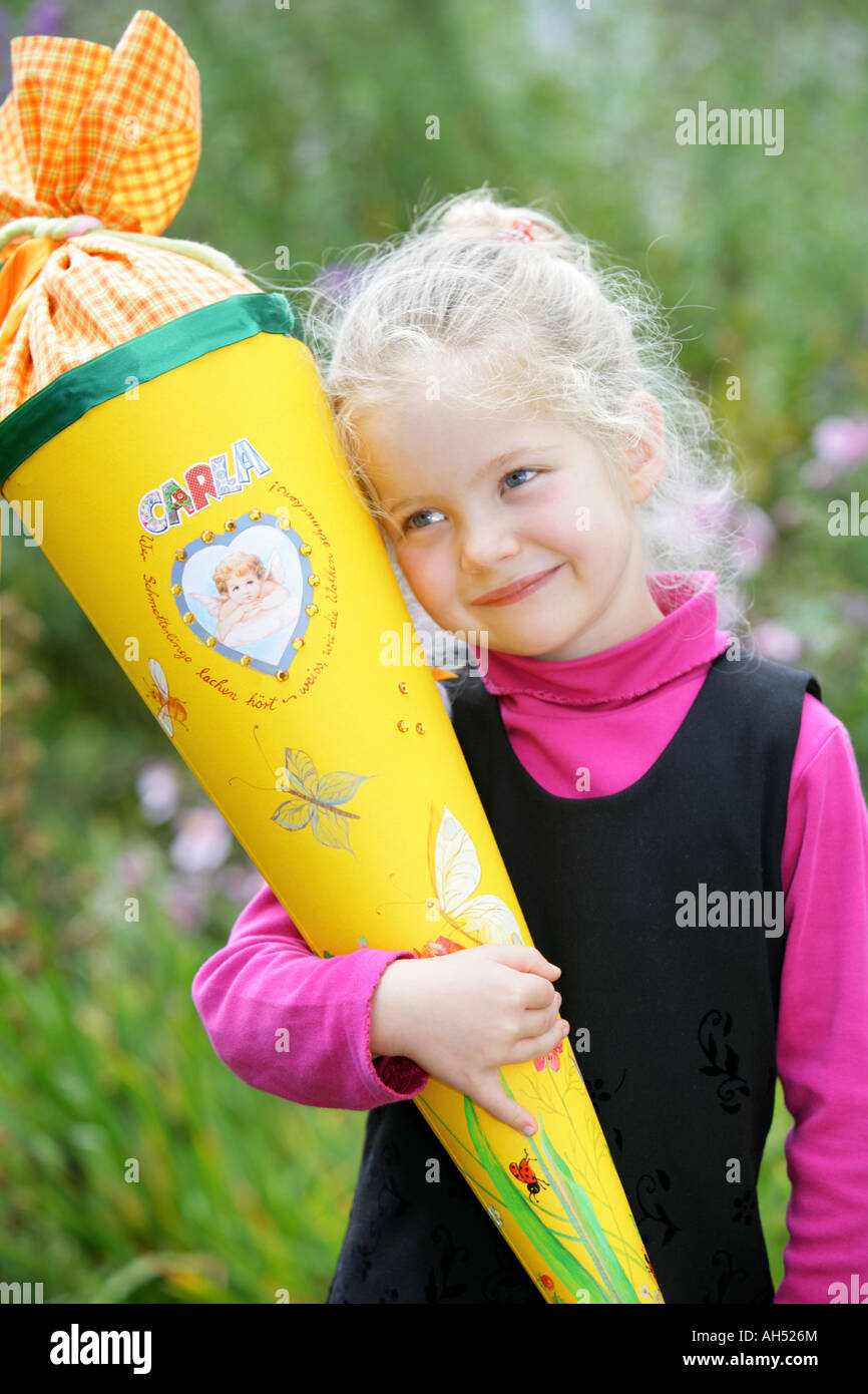 pretty blond girl with schoolcone paper funnel Stock Photo - Alamy
