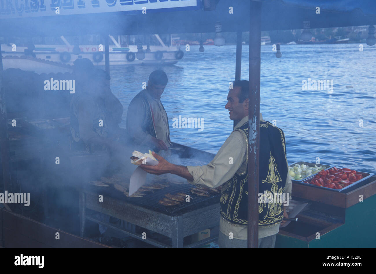 Cooking fish on the Bosphorus Istanbul Stock Photo - Alamy