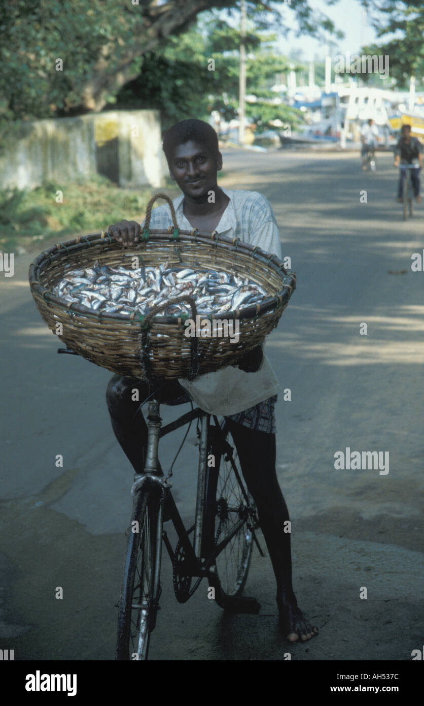 Man delivering fish on his bike Stock Photo - Alamy