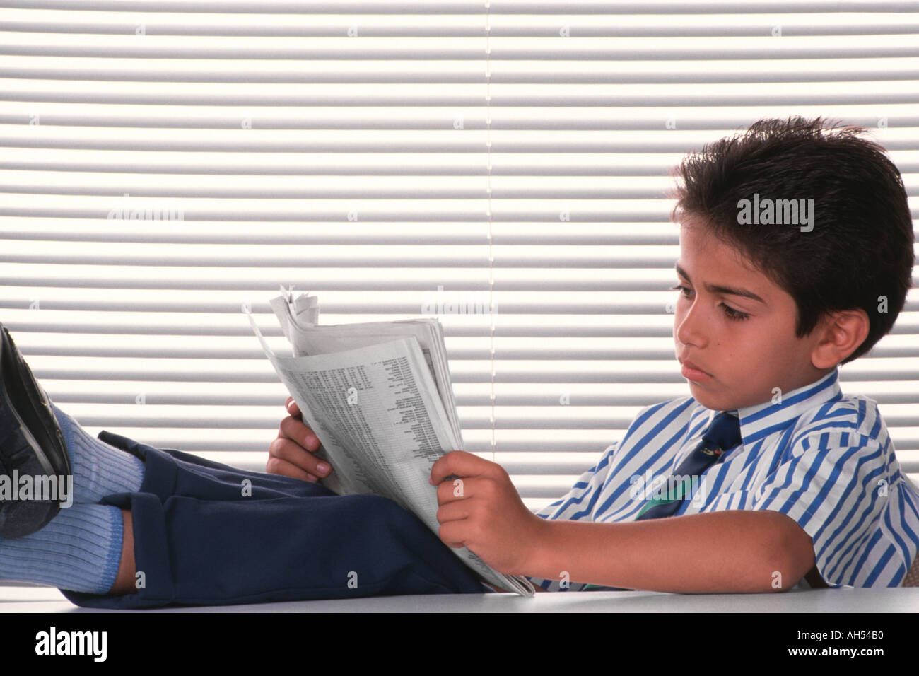 Boy reading newspaper hi-res stock photography and images - Alamy