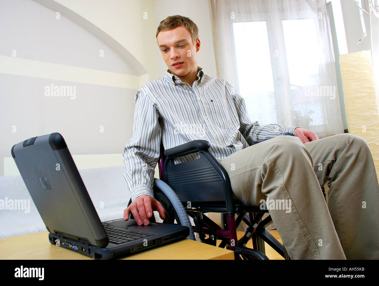indoor flat room livingroom man young boy 20 25 blonde sit wheelchair ...