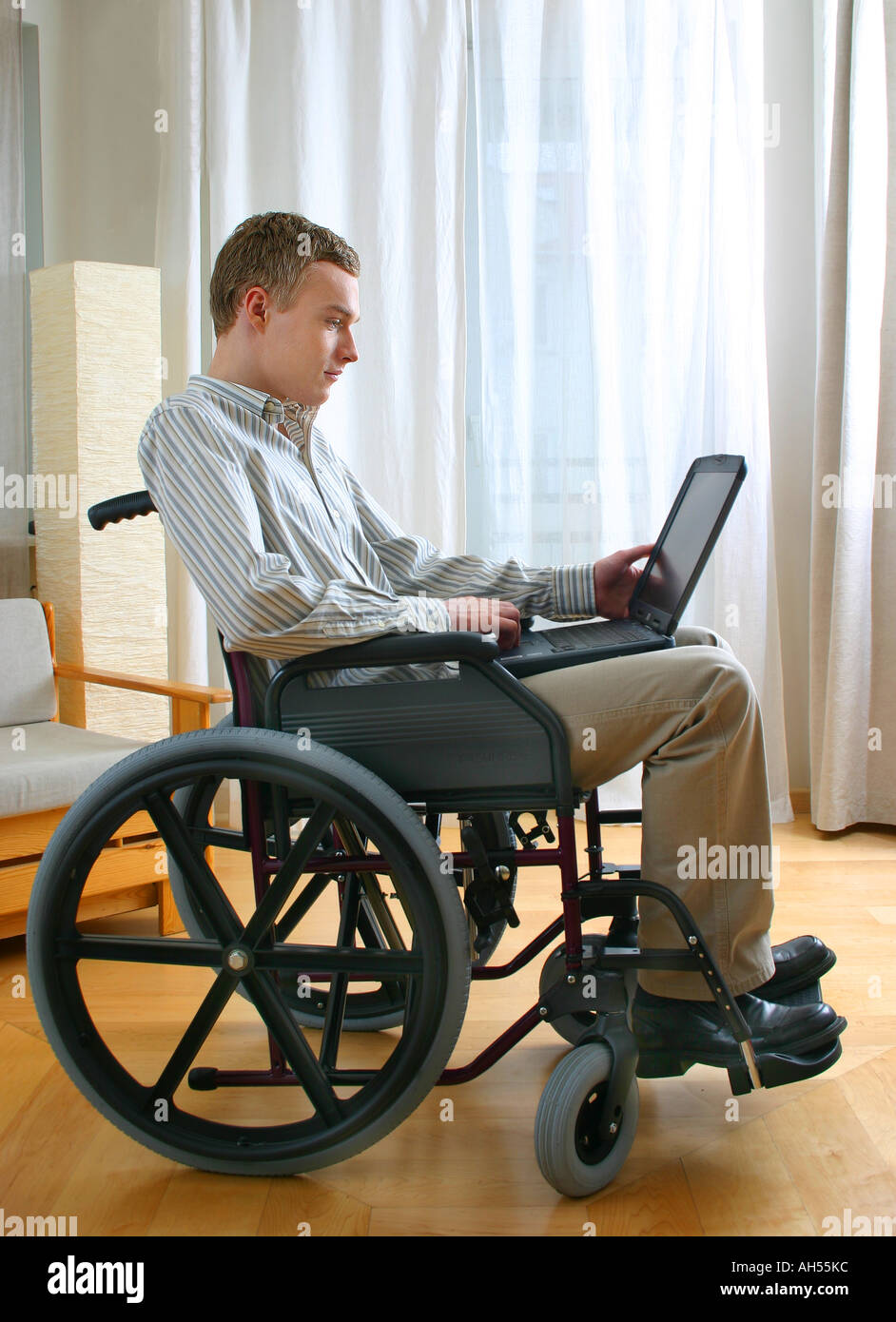 indoor flat room livingroom man young boy 20 25 blonde sit wheelchair ...