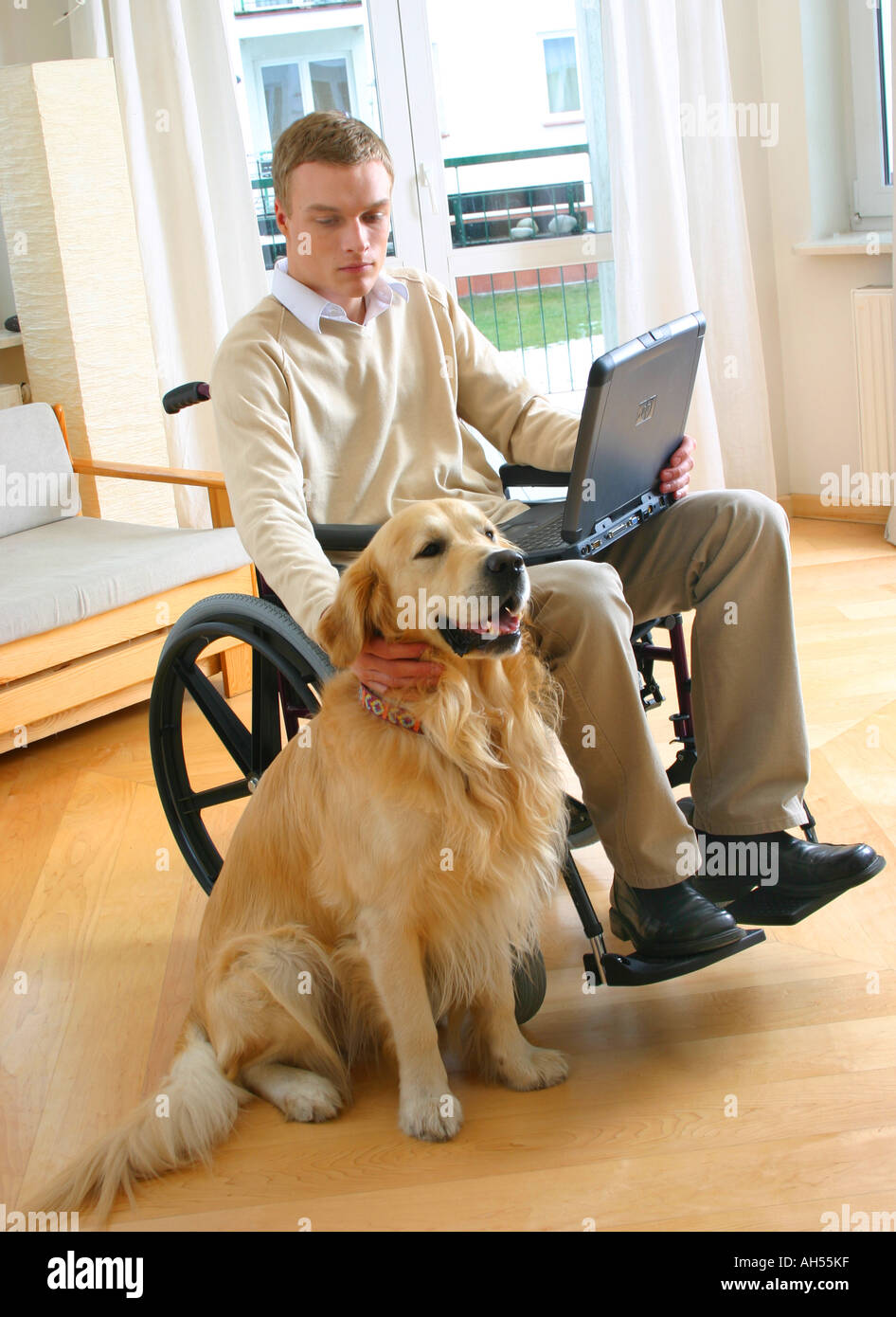 indoor flat room livingroom man young boy 20 25 blonde sit wheelchair ...