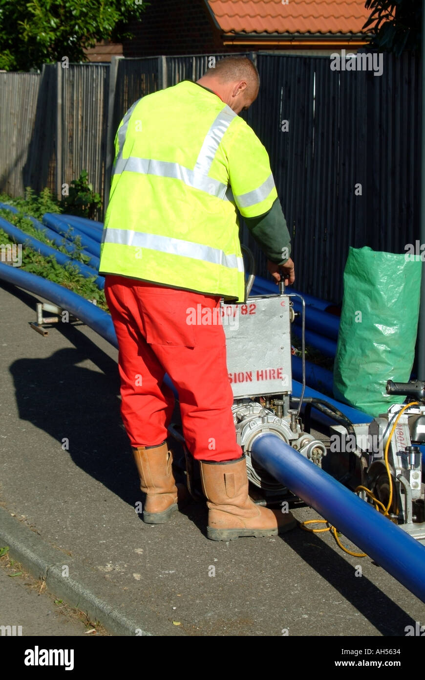 Blue plastic water main pipes in welding machine to make continuous ...