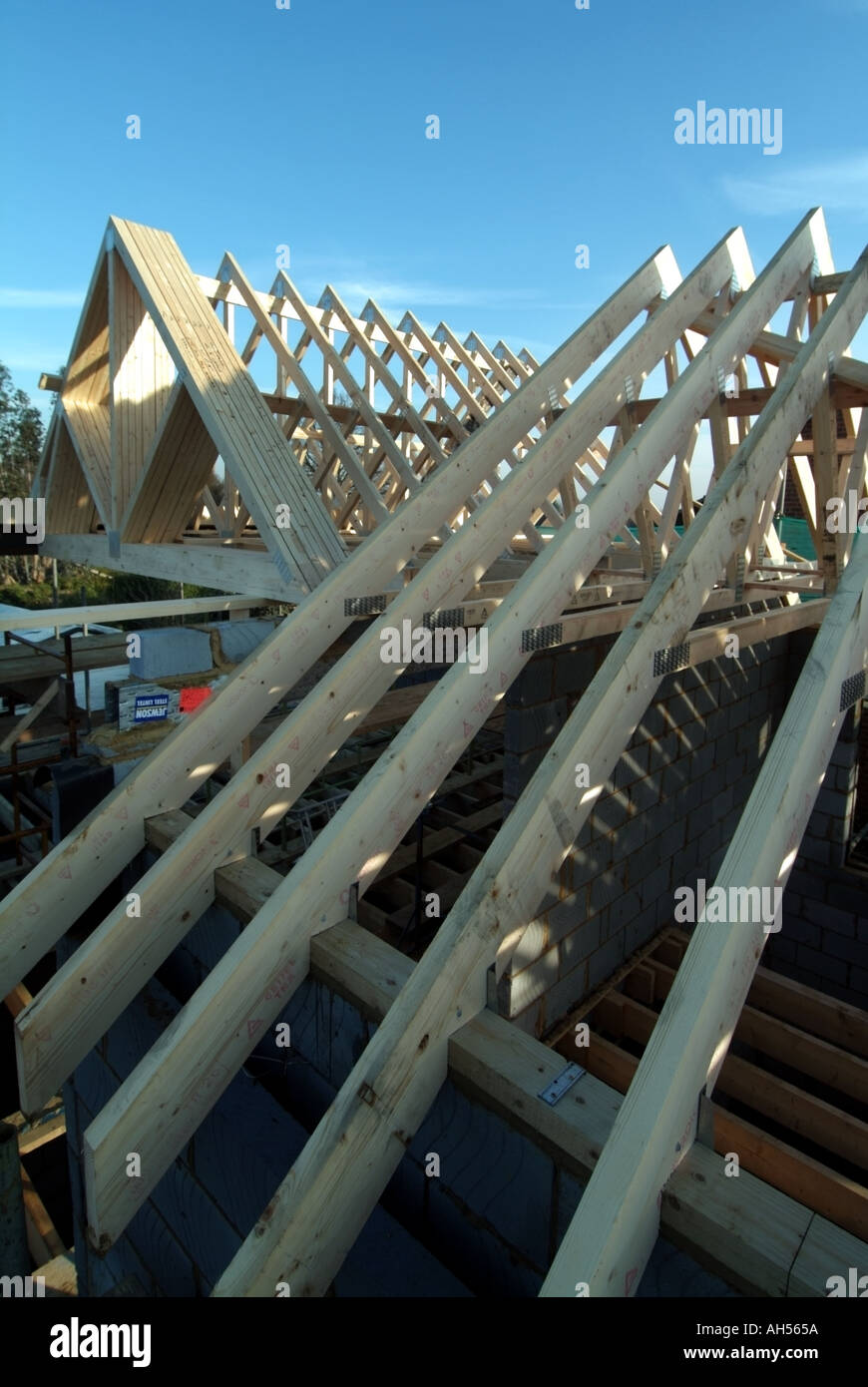 Detached house work in progress fixing prefabricated roof trusses in ...