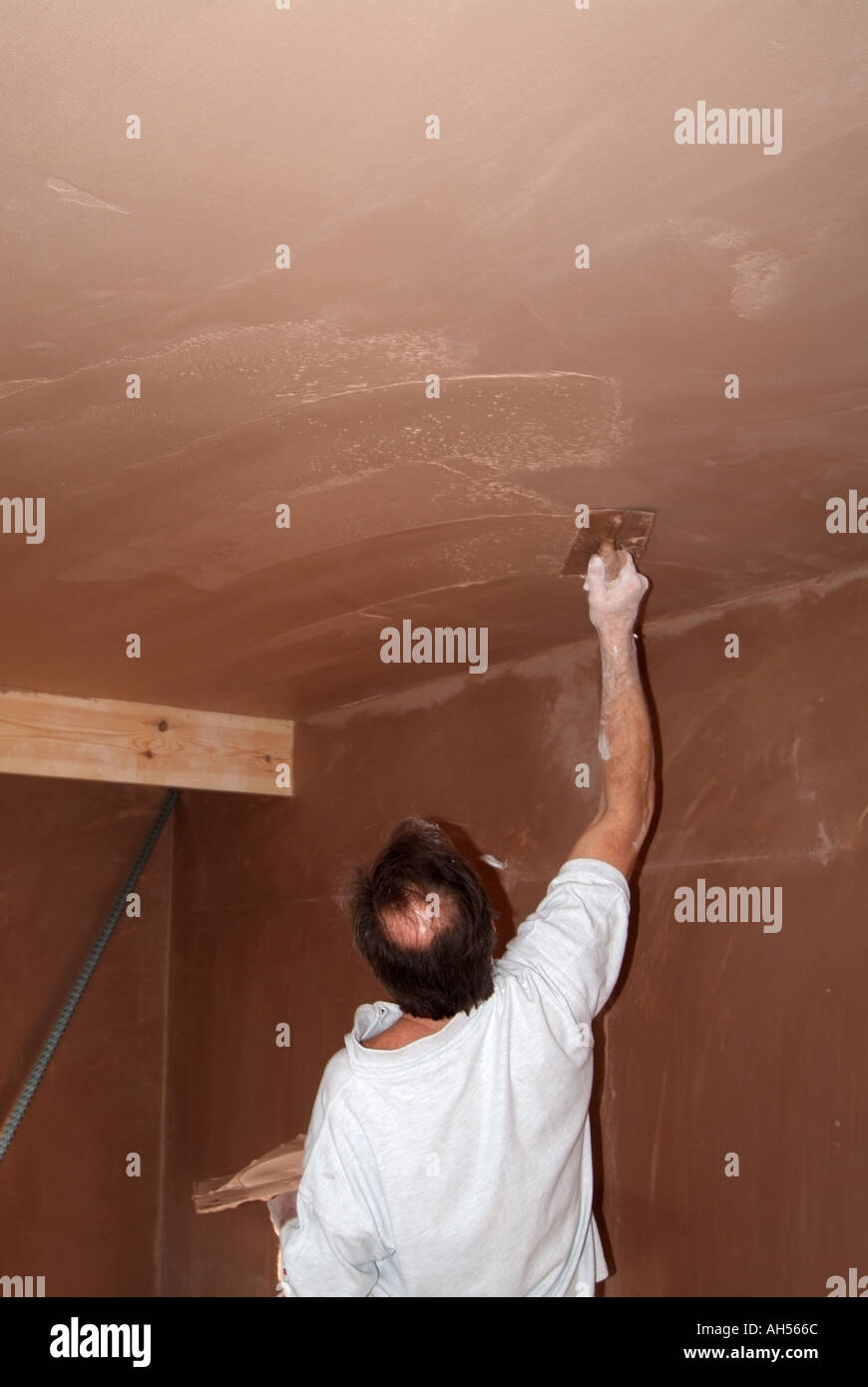 Alterations to form additional room plasterer at work applying setting ...