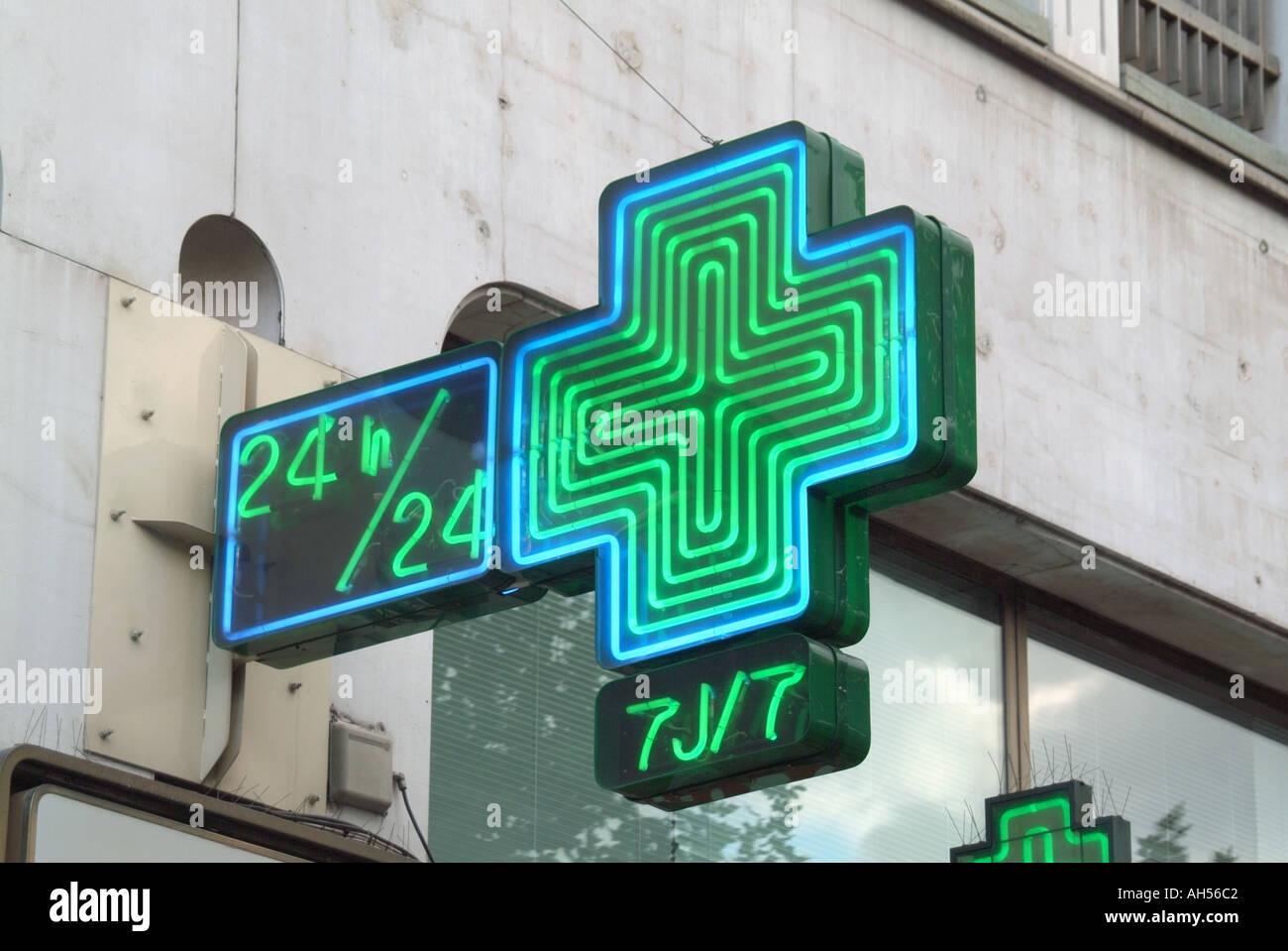 Green cross symbol of pharmacies an illuminated neon sign icon version ...