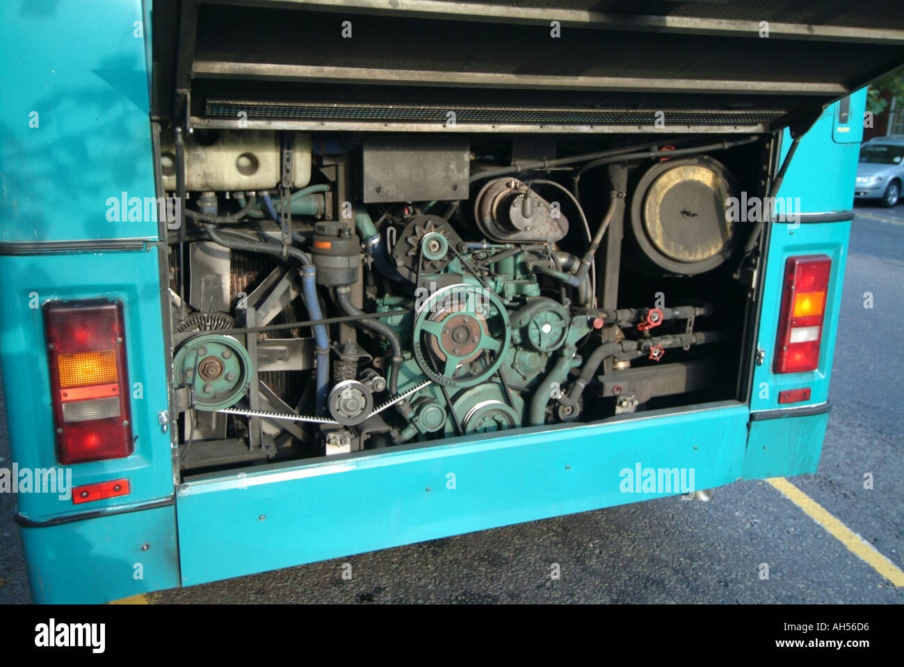 Broken down bus in high street with rear mounted engine cover raised to ...