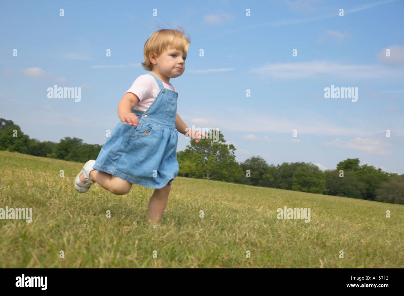 Young Girl Running in Open Field Stock Photo - Alamy