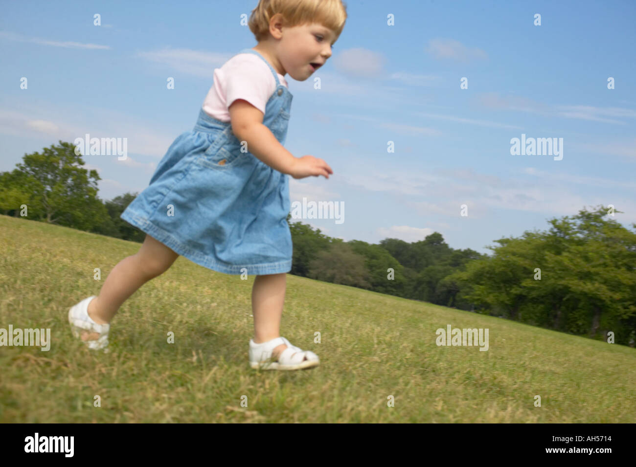 Young Girl Running in Open Field Stock Photo - Alamy