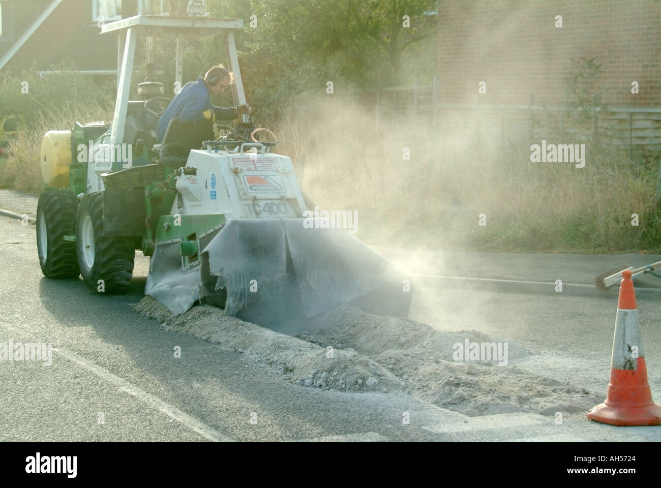 Street works to cut trench in tarmac covered concrete road prior to ...