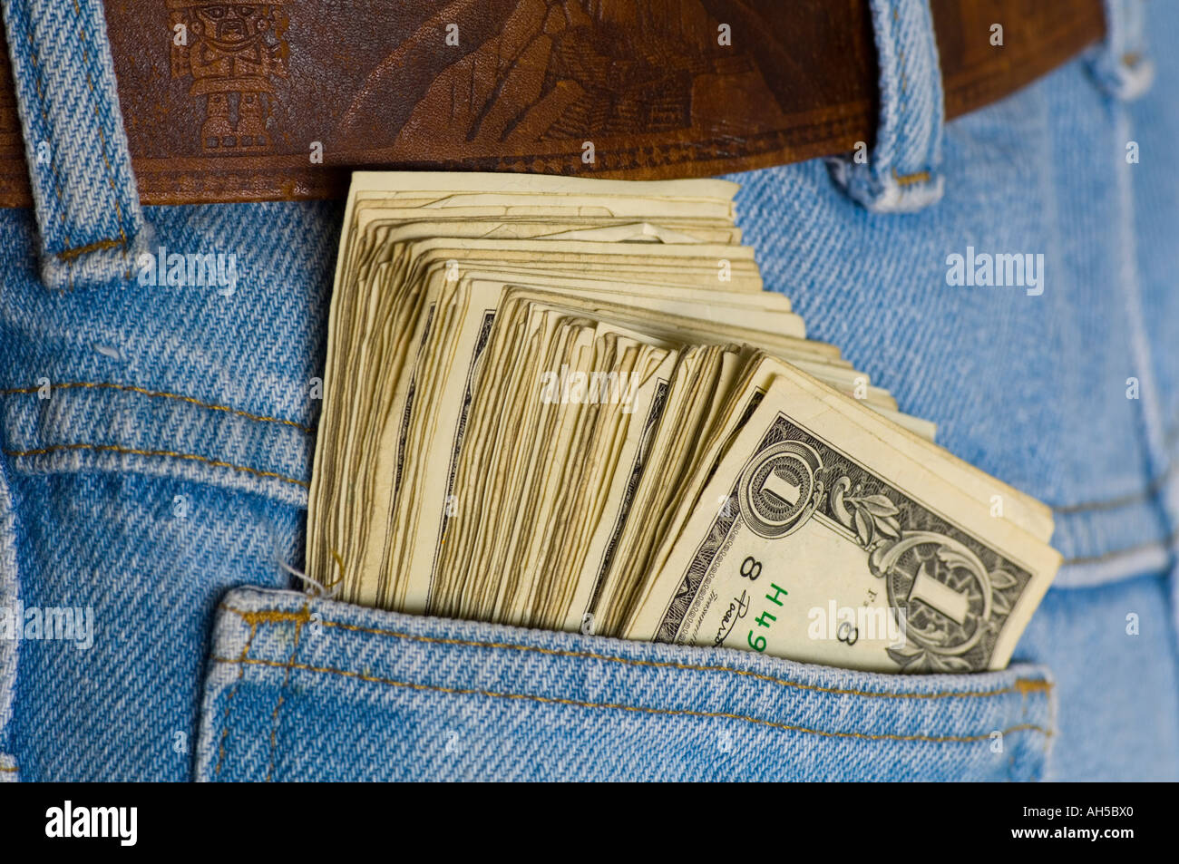 stack of dollar bills in hip pocket of pants Stock Photo - Alamy