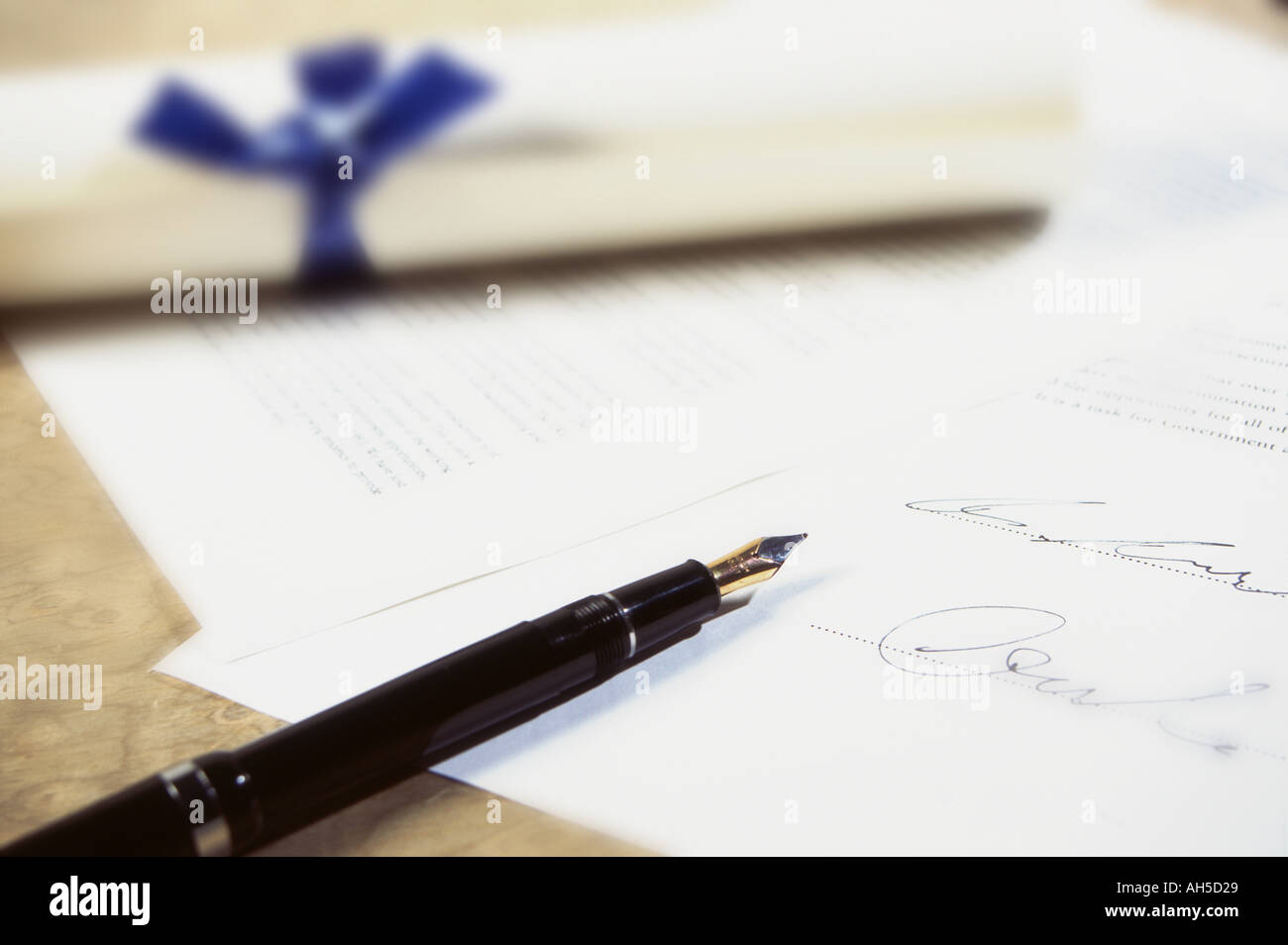 Legal documents tied with ribbon with pen Stock Photo - Alamy