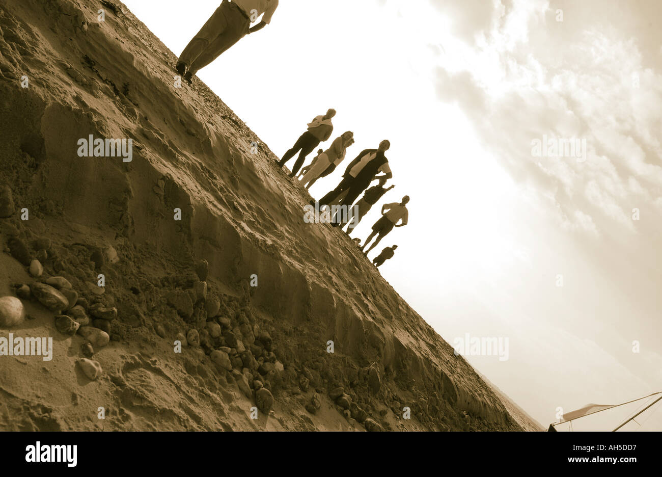 Group of people walking along path at seafront sepia effect Stock Photo ...