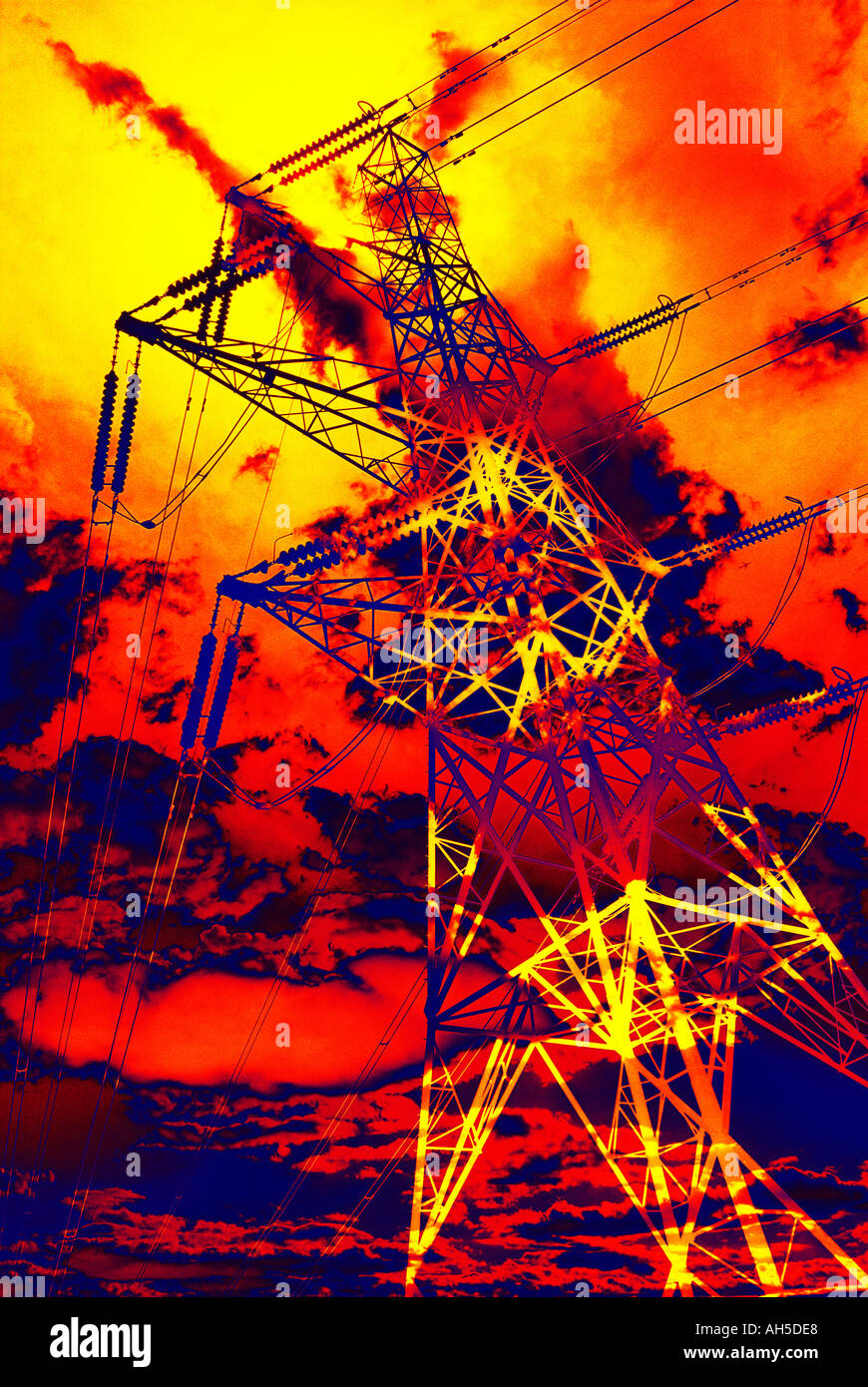 Electrical pylon or transmission tower with flaming red and yellow sky ...