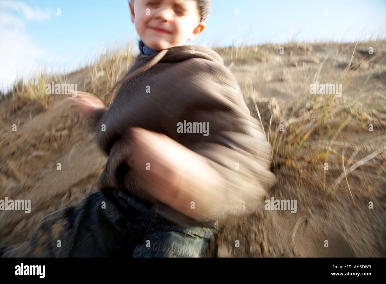 boy falling down sand dune Stock Photo - Alamy