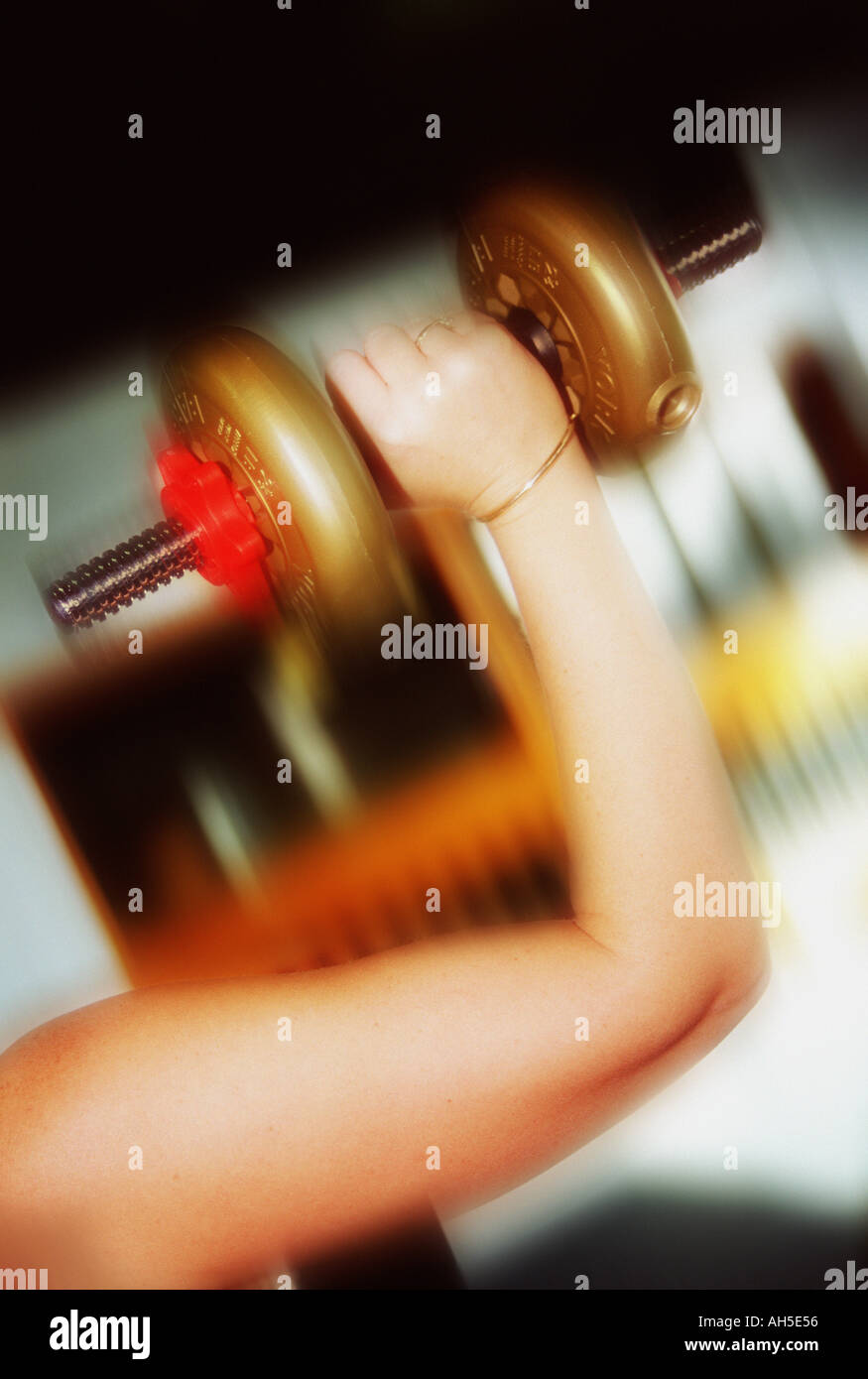 Female arm lifting weight in exercise studio Stock Photo - Alamy