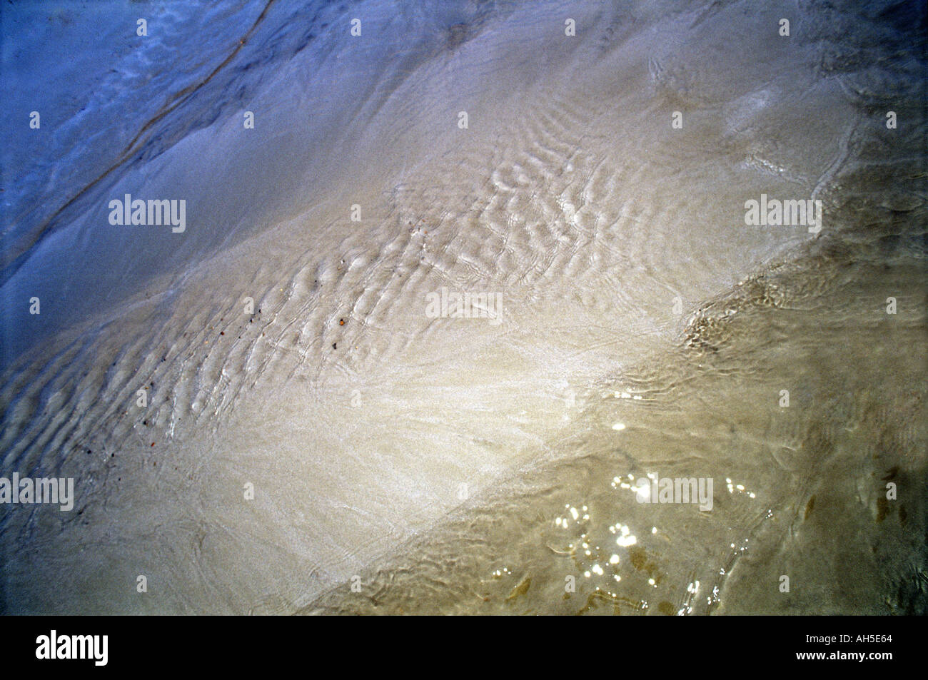 Ripples of sea water in the sand on a beach Stock Photo - Alamy