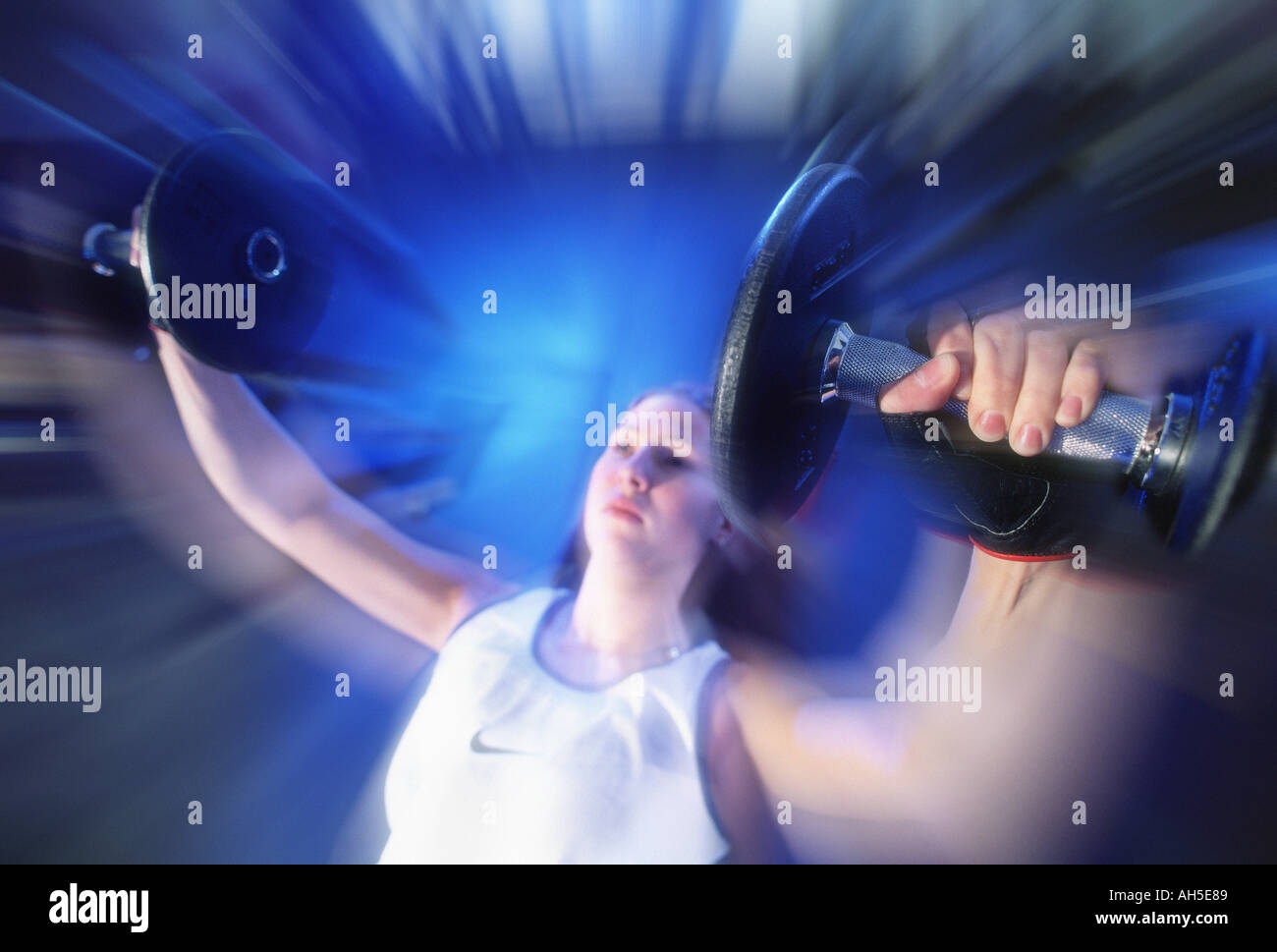 Female exercising with weights in gym Stock Photo - Alamy