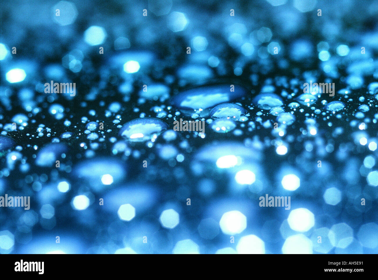 Rainwater reflecting on shiny blue surface Stock Photo - Alamy