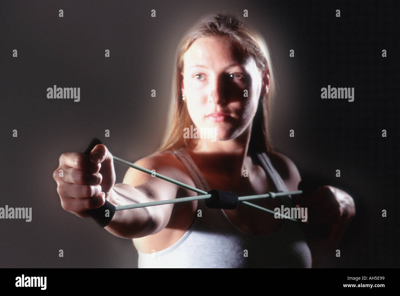 Female using arm stretching exercise equipment Stock Photo - Alamy