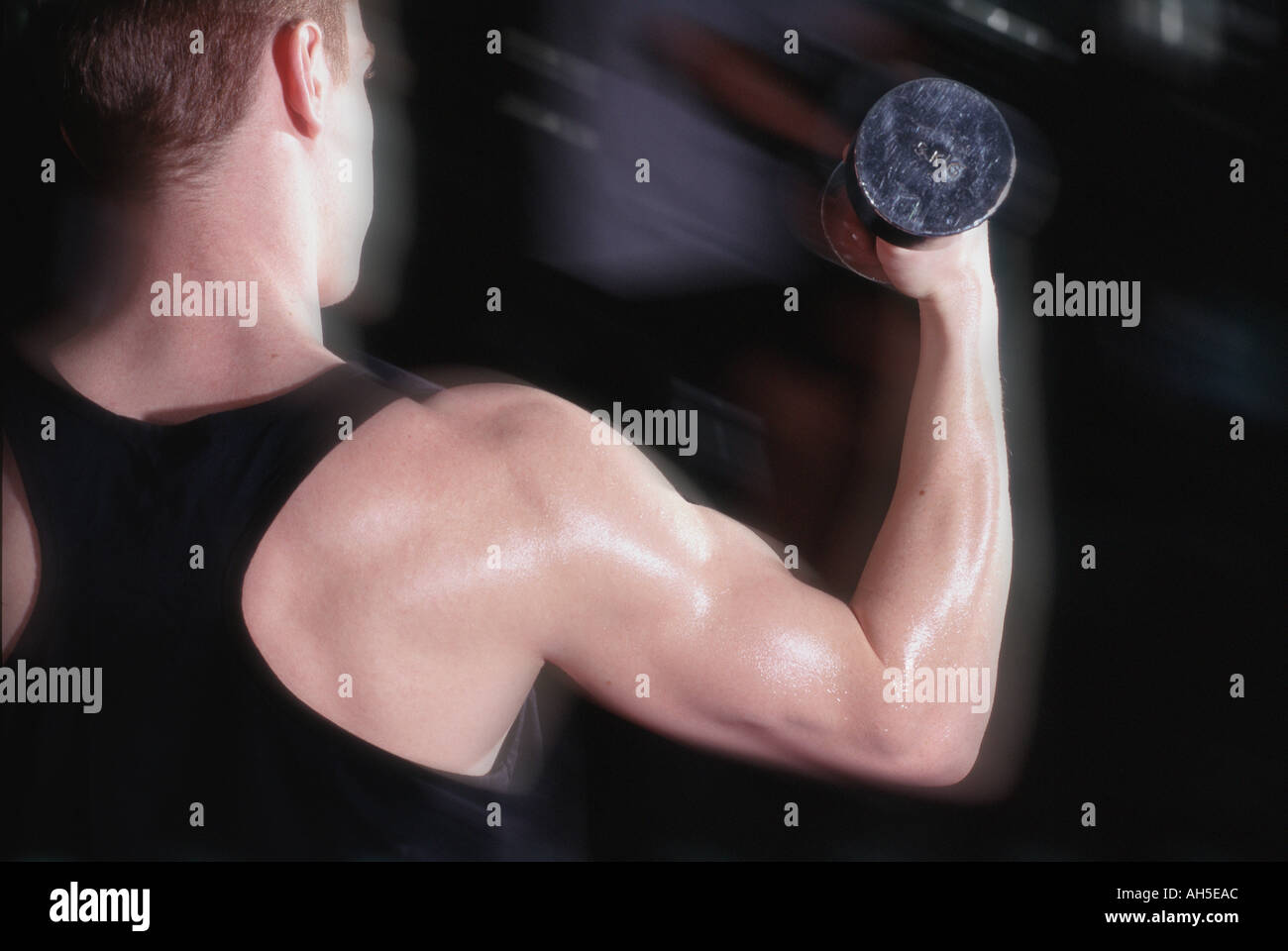 Male using hand weights Stock Photo - Alamy