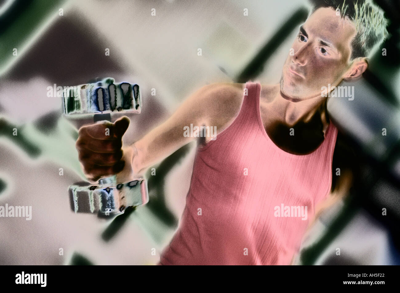Male exercising with heavy hand weights in gym posterised effect Stock ...