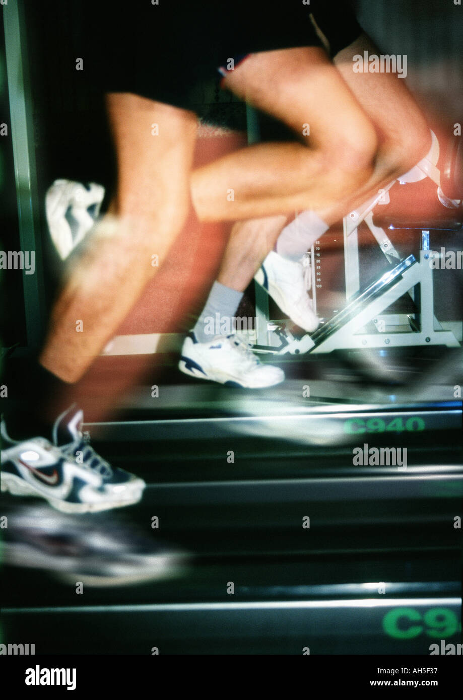 Legs exercising on running machines in gym Stock Photo - Alamy