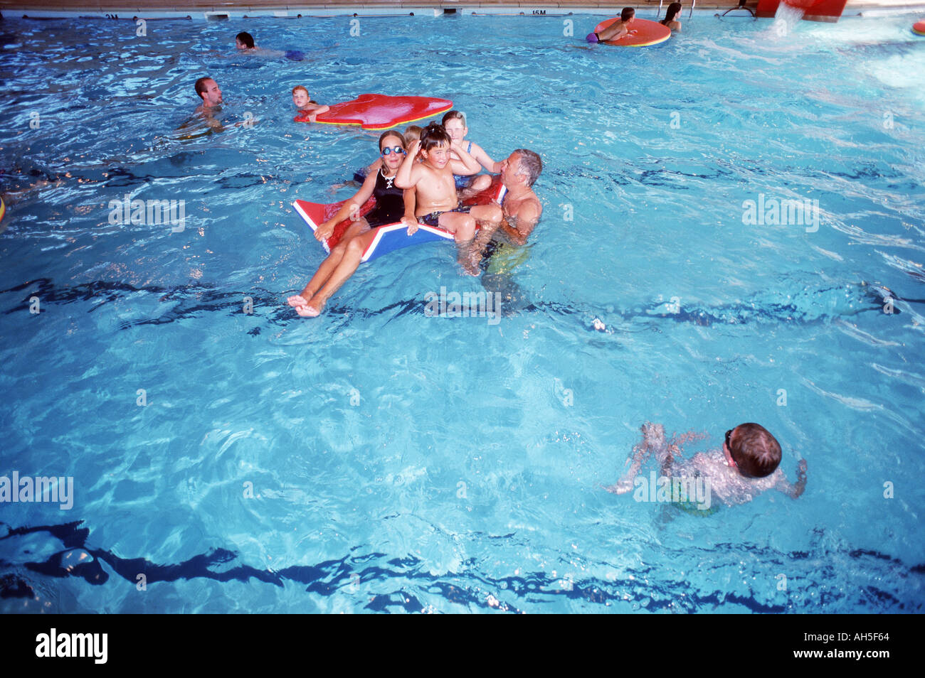 Family having fun in the swimming pool Stock Photo - Alamy