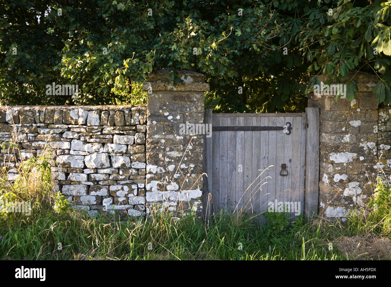 A gate to Misarden Park in the Cotswold village of Miserden ...