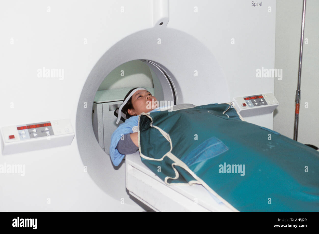 Woman patient in hospital radiology diagnostic department having a CAT ...