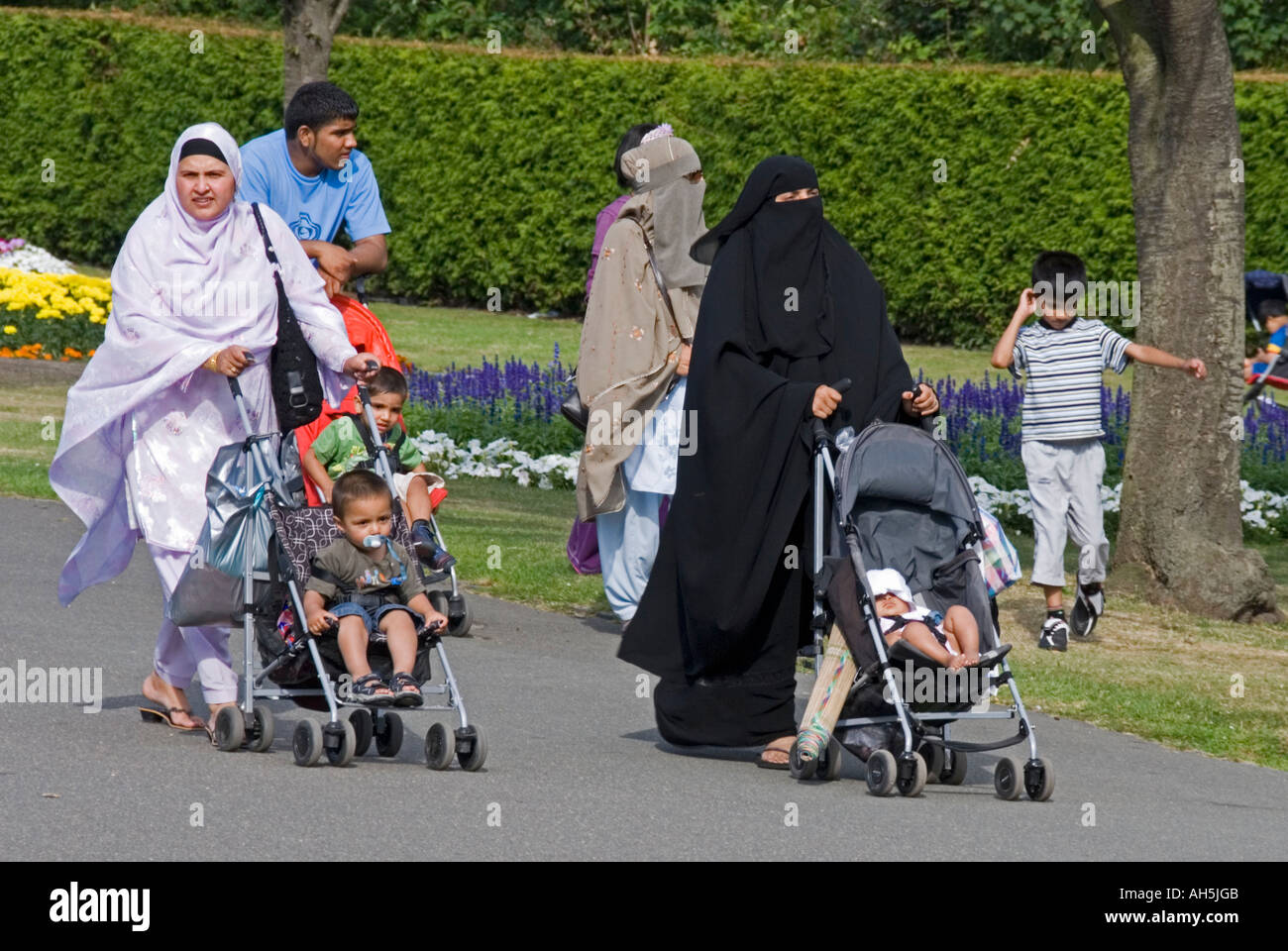 Asian family walking in the park Stock Photo - Alamy