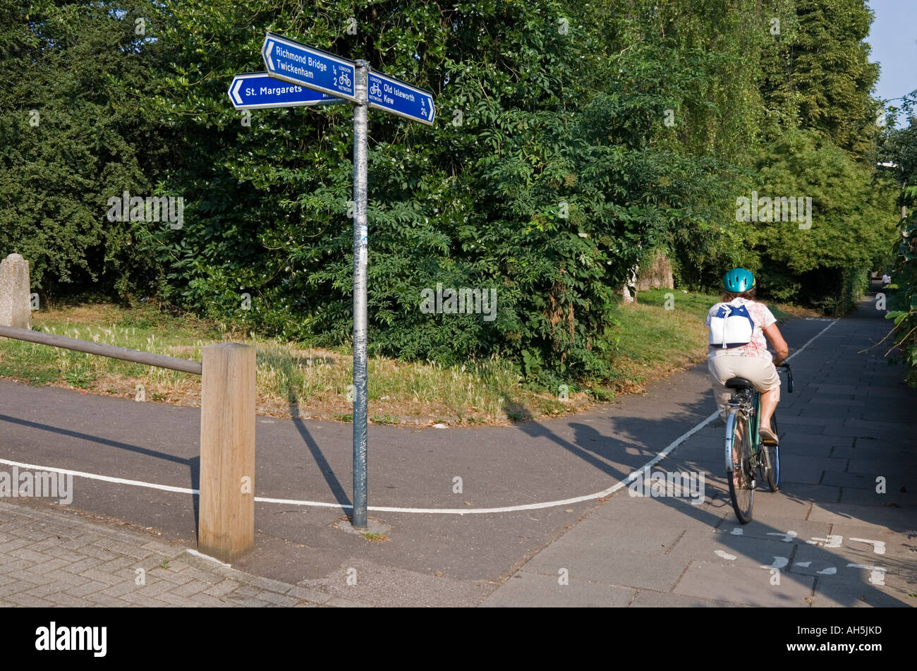 Cyclists using cycle path by the river Thames in Richmond London Stock ...