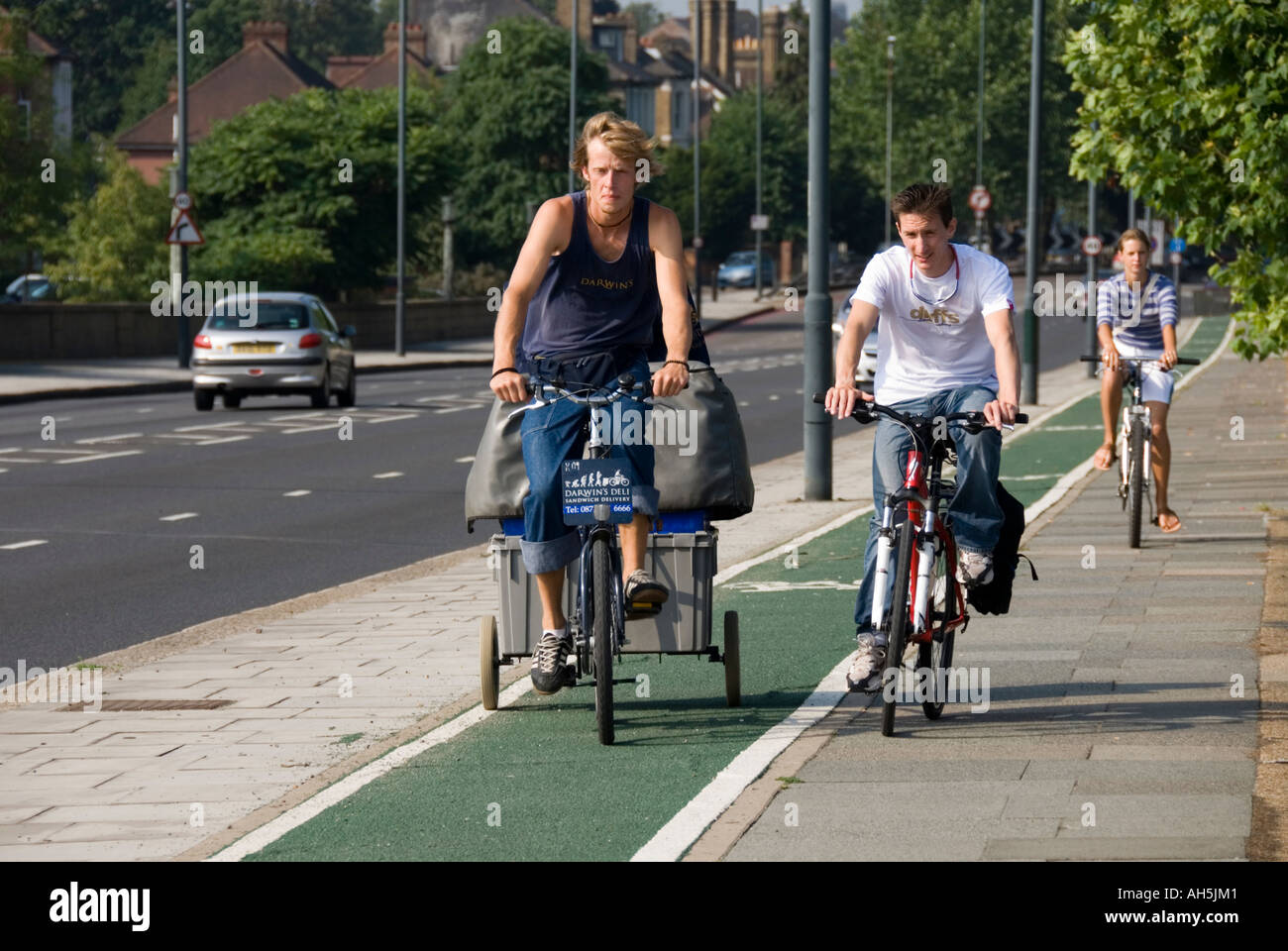 Cyclists using cycle path and riding on pavement Stock Photo - Alamy