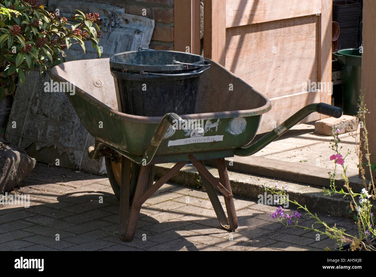 A wheelbarrow and bucket Stock Photo - Alamy