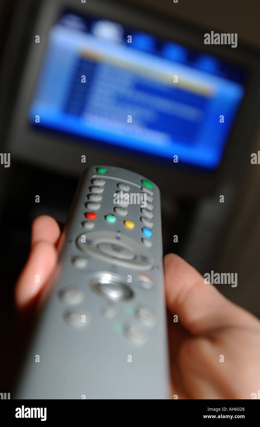 TV control with TV in background Stock Photo - Alamy