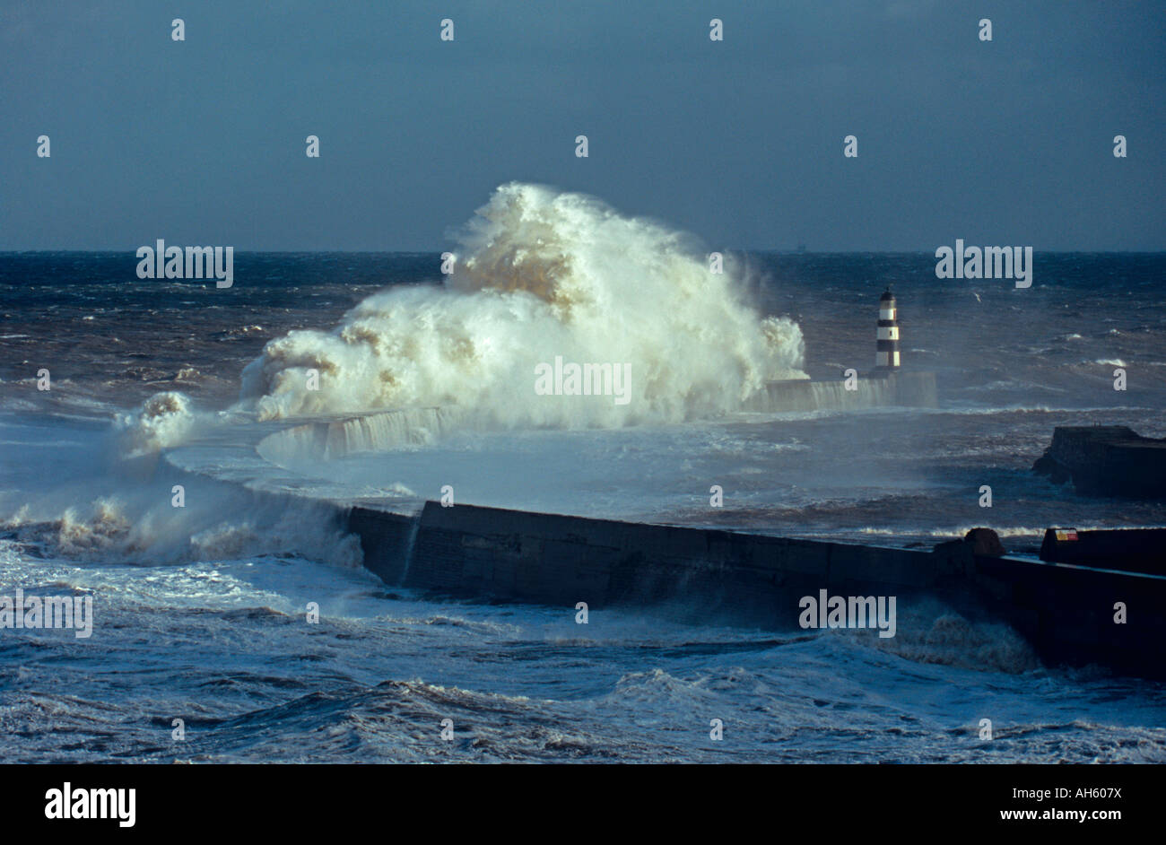 Massive waves break over the Pier and Lighthouse during a winter storm ...