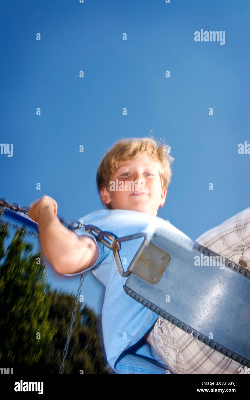 Student taking a break at recess on the school swing set Stock Photo ...